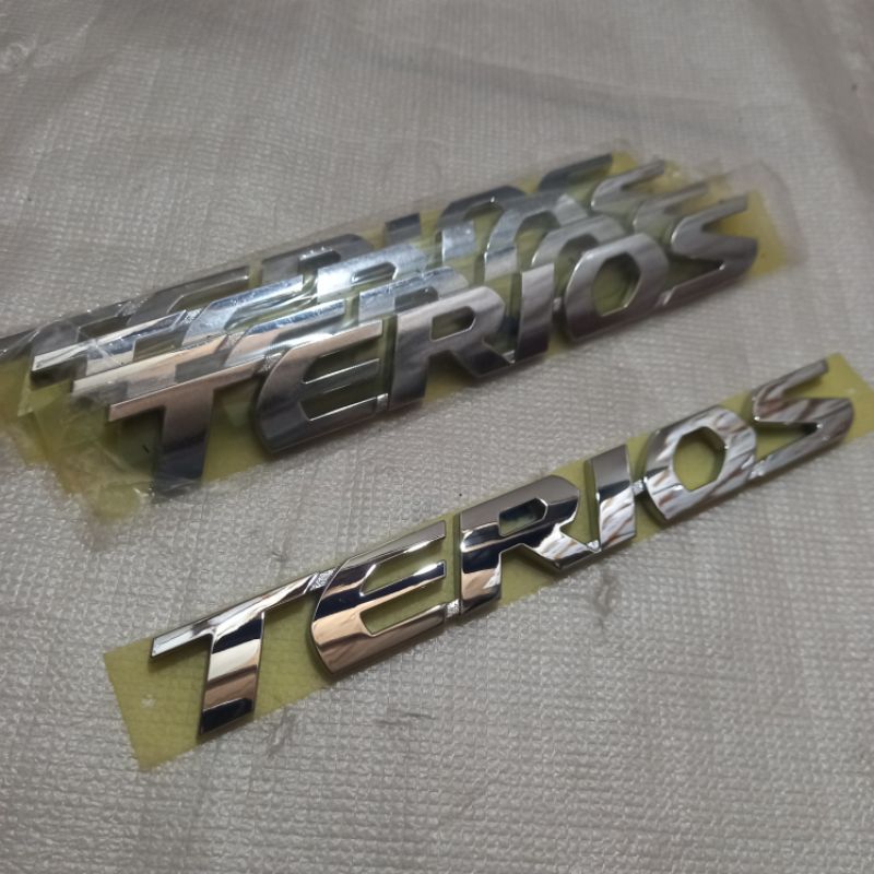 Jual Emblem TERIOS/Logo TERIOS ORIGINAL sudah ada lem 3M | Shopee Indonesia