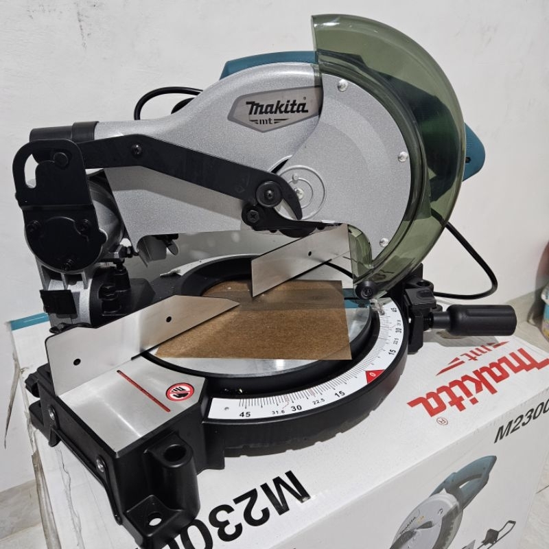 Jual Mesin Potong Gergaji Kayu Duduk Aluminium Makita M2300B Compound Miter Saw 255mm 10" Putra ...