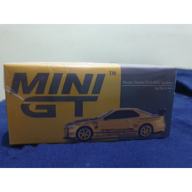 Jual 1/64 mini gt - nissan skyline GTR R34 top secret gold segel | Shopee Indonesia